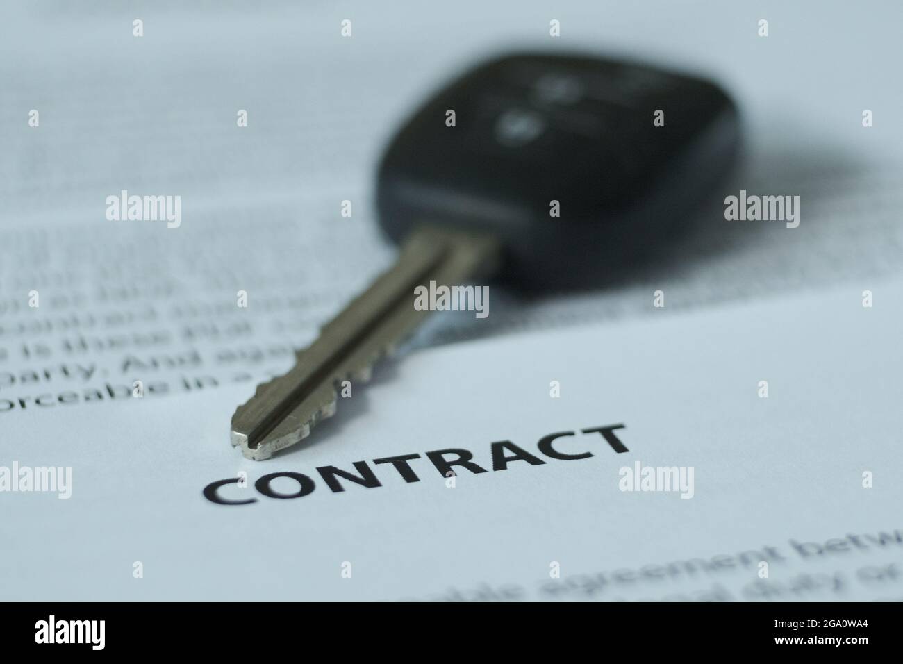 There is a contract and car keys on the table, the emphasis is on the ...