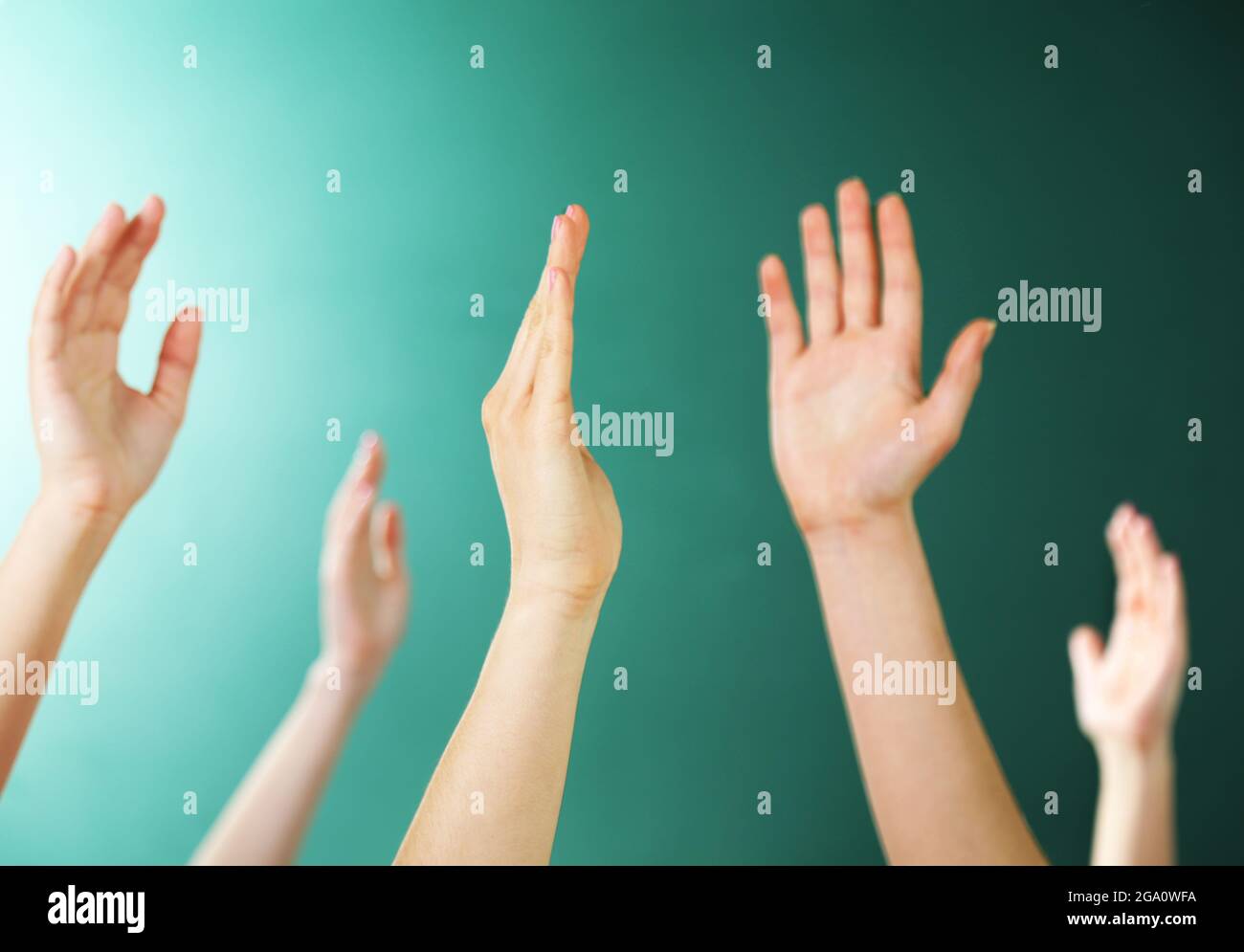 Raised hands on blackboard background in class Stock Photo - Alamy