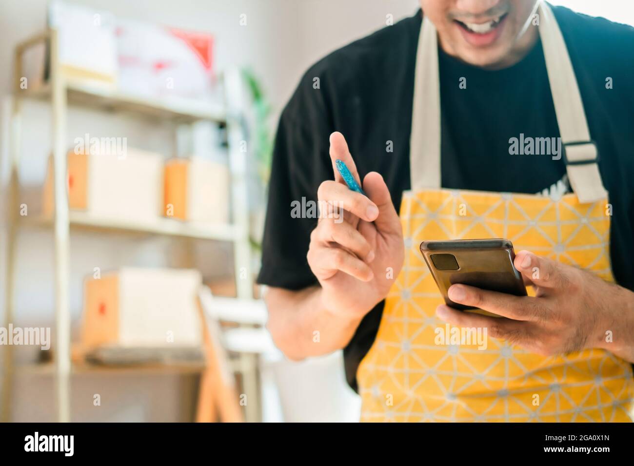 Asian male hand writing order product list on note for online customer ...