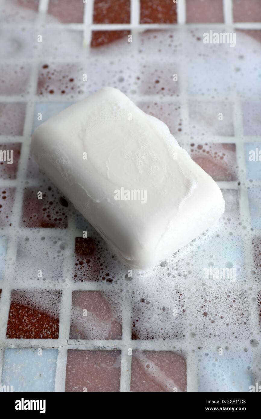 Soap with bubble on mosaic tiles background Stock Photo - Alamy