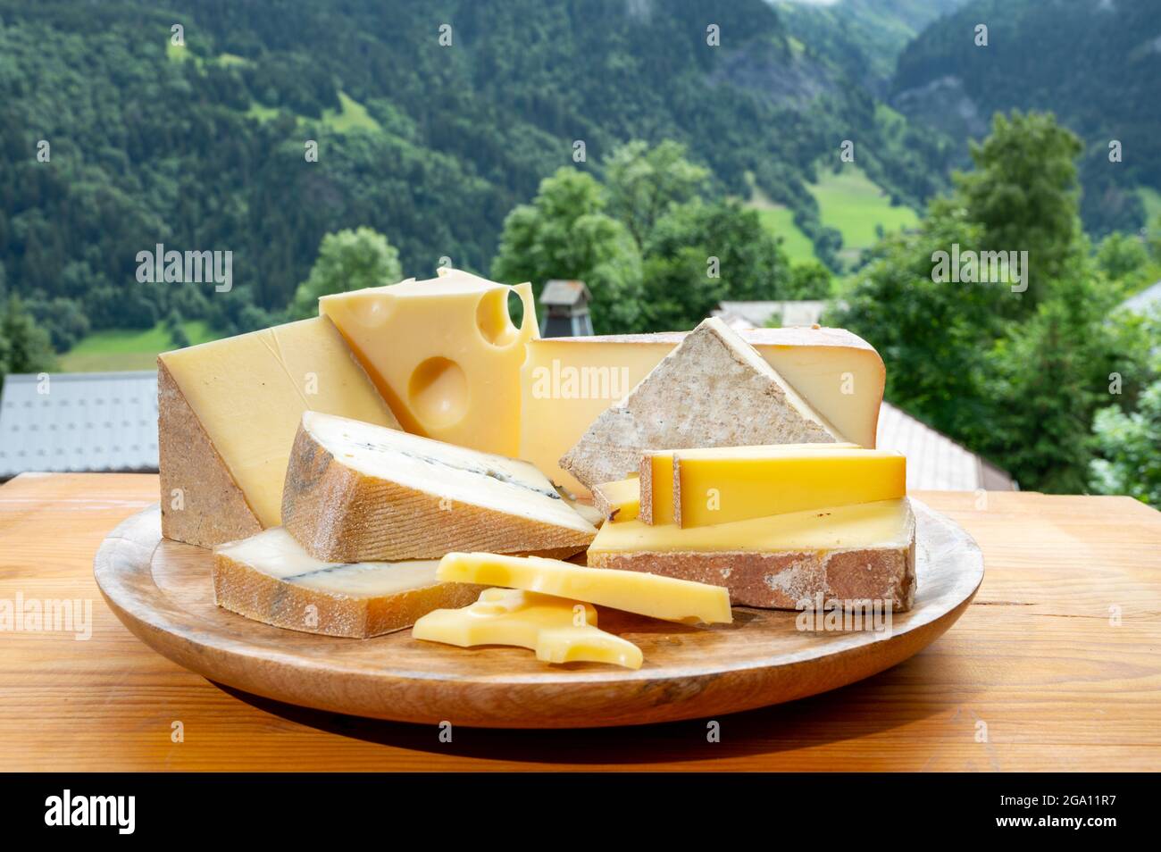 Cheese collection, wooden board with French cheeses comte, beaufort ...