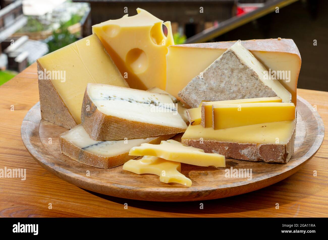 Cheese collection, wooden board with French cheeses comte, beaufort ...
