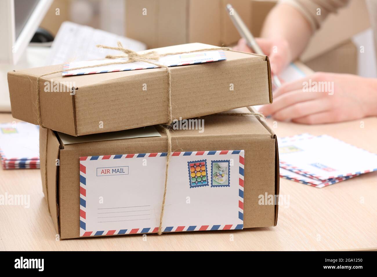 Cardboard boxes on work place in post office Stock Photo - Alamy