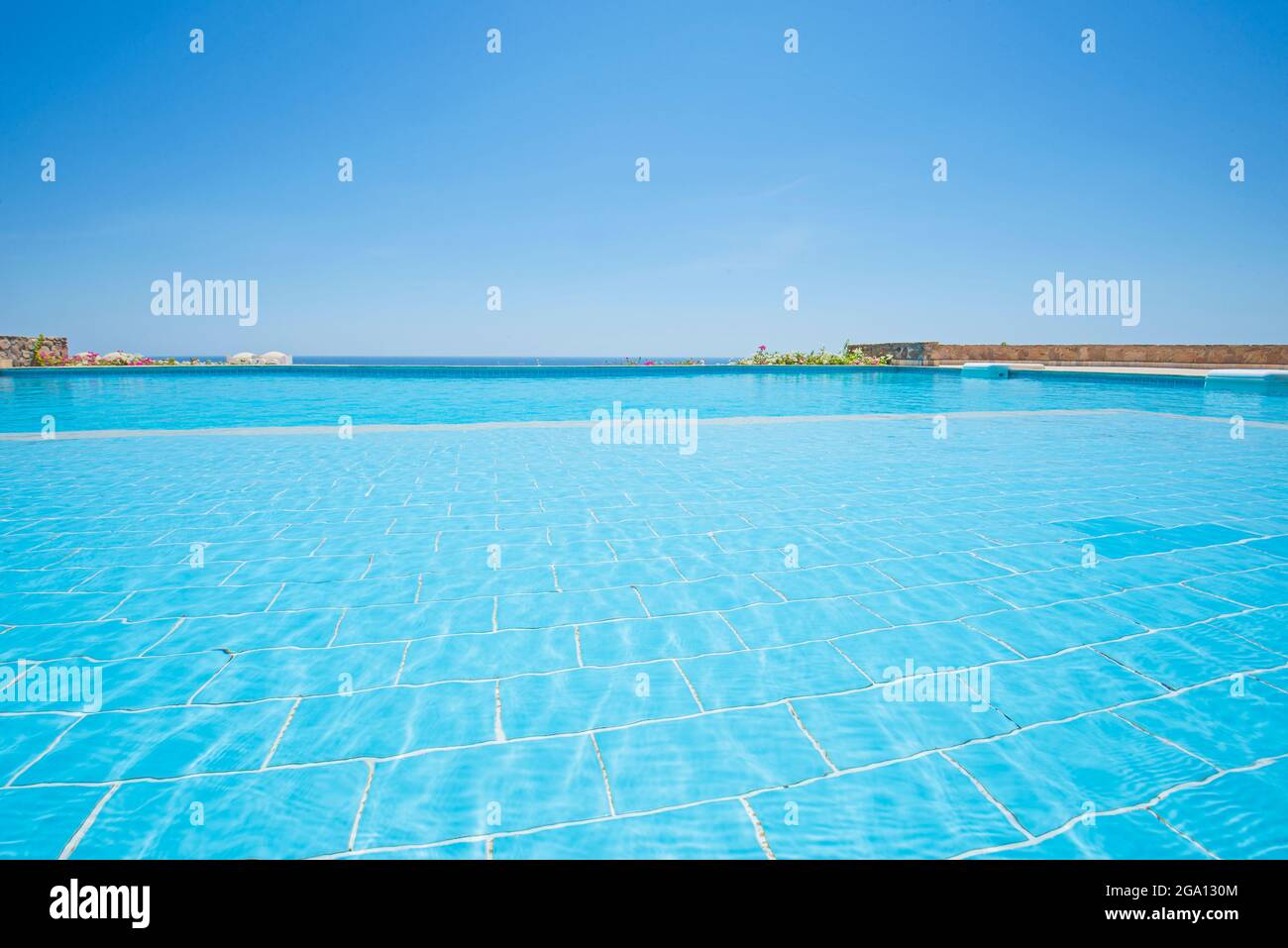 Large outdoor infinity swimming pool at a luxury tropical hotel resort ...
