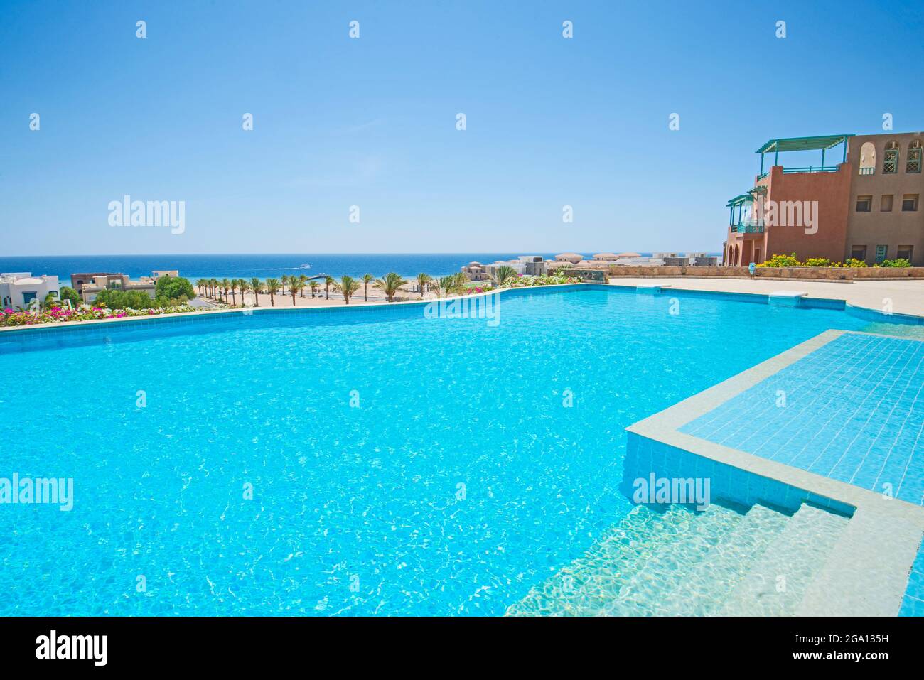 Panoramic view of large outdoor swimming pool at a luxury tropical ...