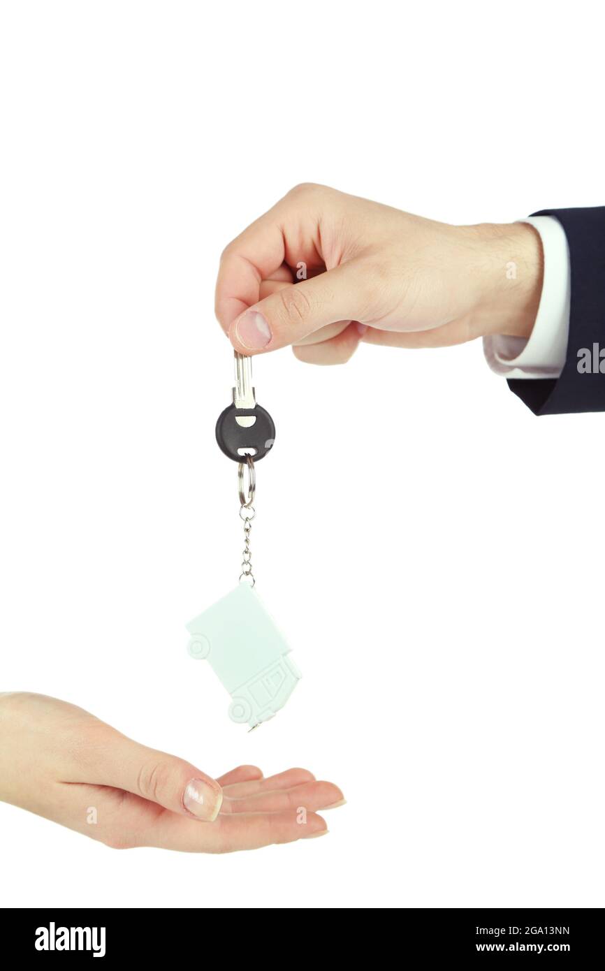 Male hand giving key with trinket to female hand isolated on white ...