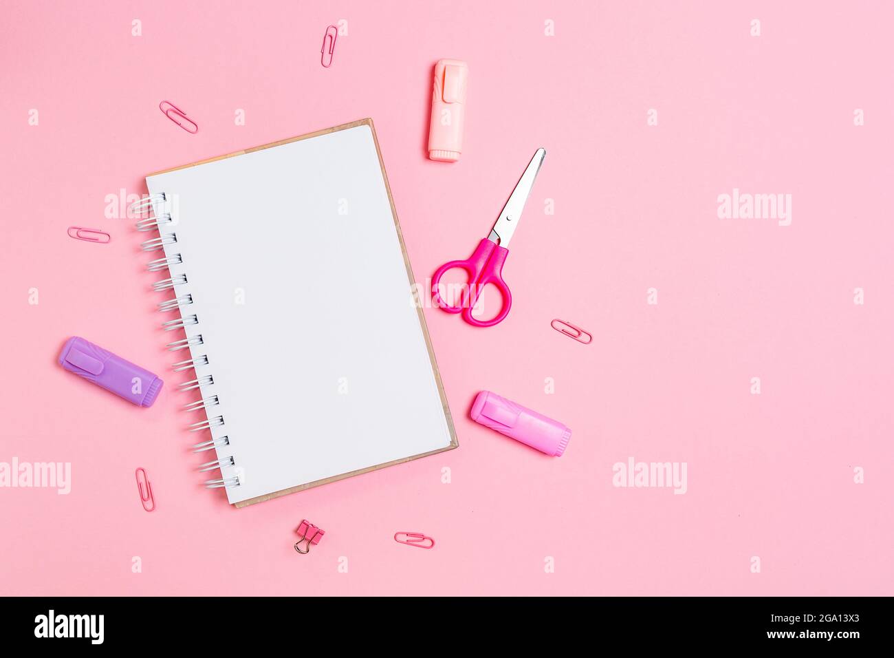 Back to school. Composition with copybook and pink office supplies on ...