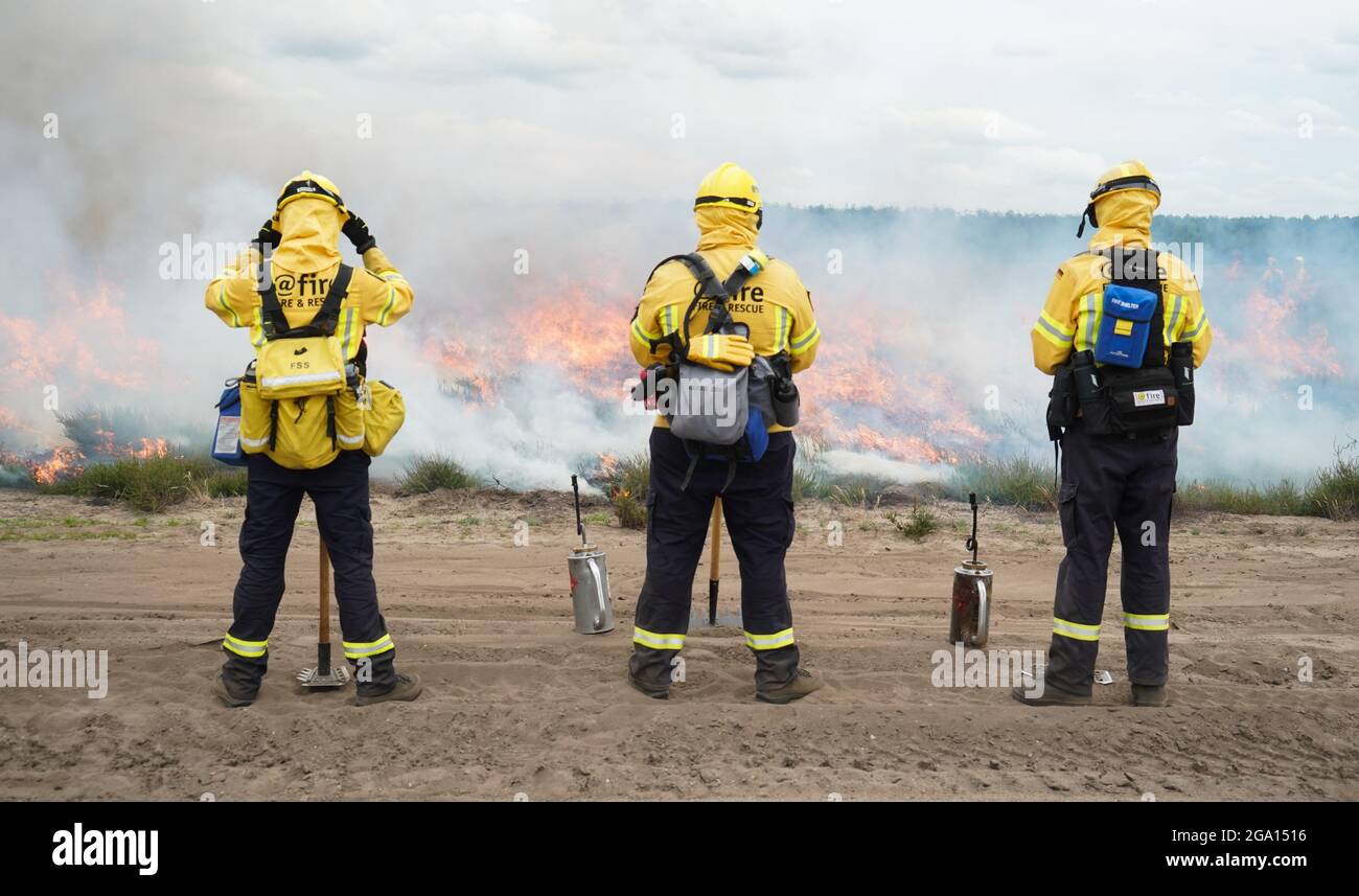 28 July 2021, Brandenburg, Brück: Members of the organisation @fire ...