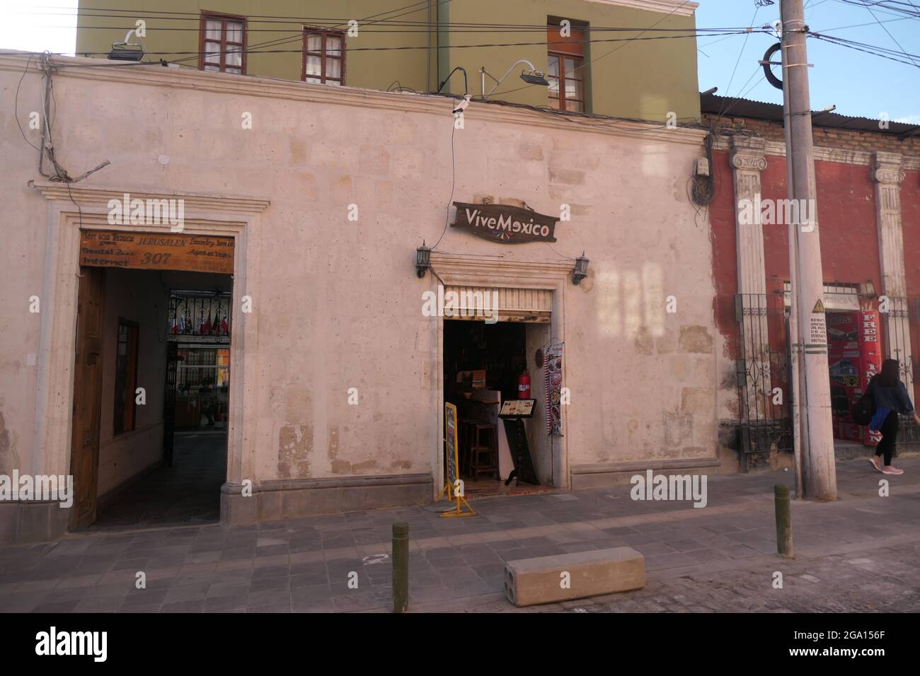 Bar in Peru old building with a sign saying Vive Mexico pink plaster on ...