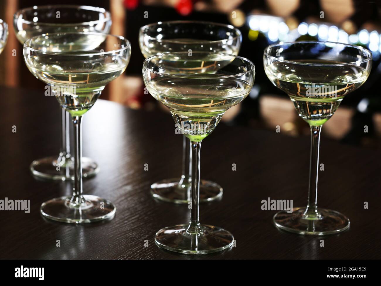 Glasses of cocktails on bar background Stock Photo - Alamy