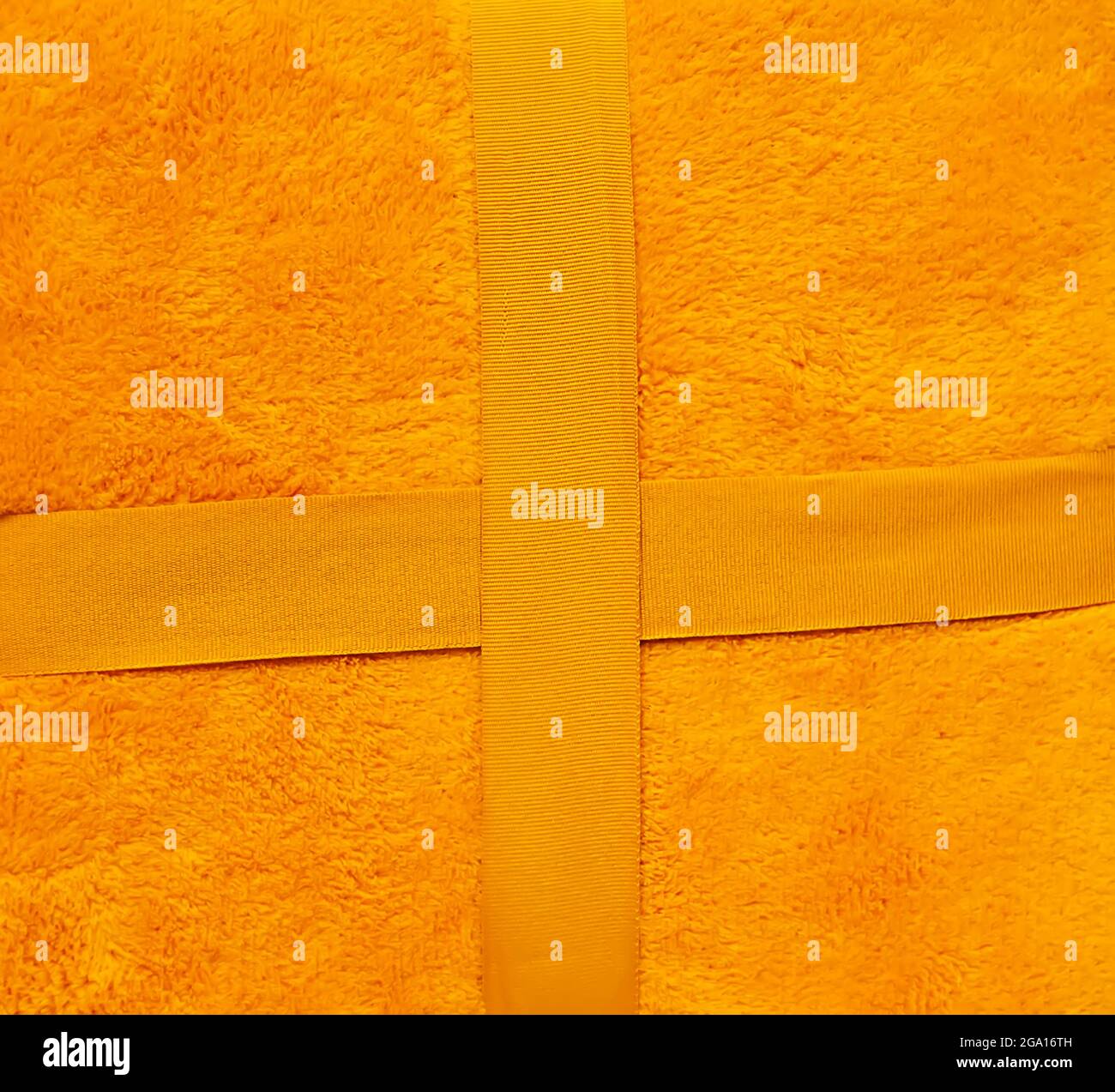 Warm soft yellow textile surface close up. Synthetic fabric texture ...