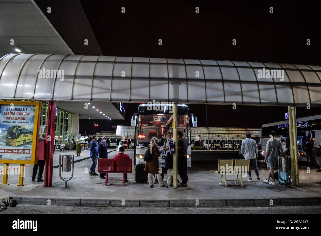 Passengers wait for their busses at the central intercity bus terminal ...