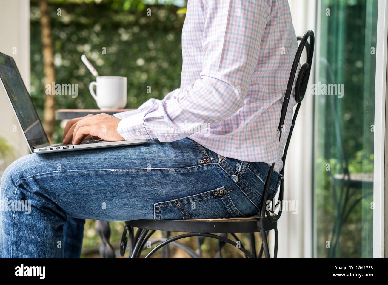 Closeup shot of a male working on his laptop - posture ergonomics ...