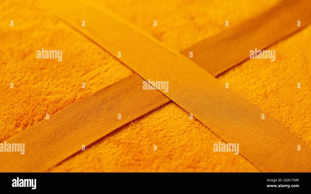 Warm soft yellow textile surface close up. Synthetic fabric texture ...
