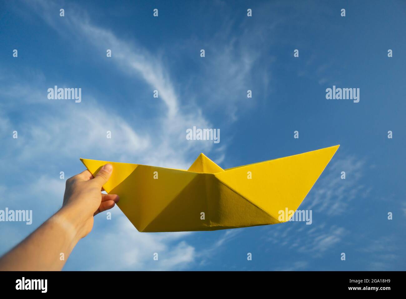 Big yellow paper boat with blue sky and white clouds Stock Photo - Alamy