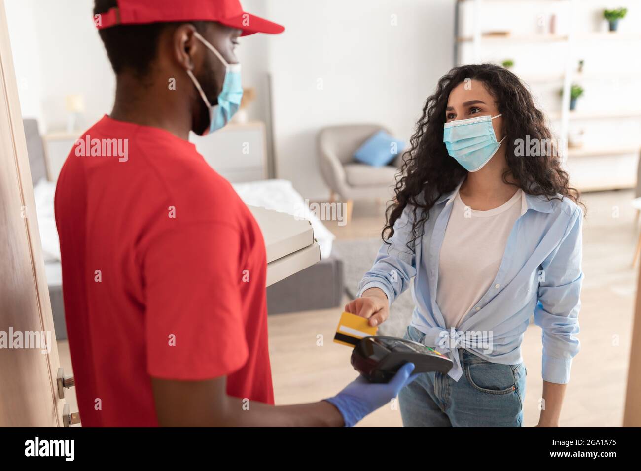Portrait of black man holding POS machine for payment Stock Photo - Alamy