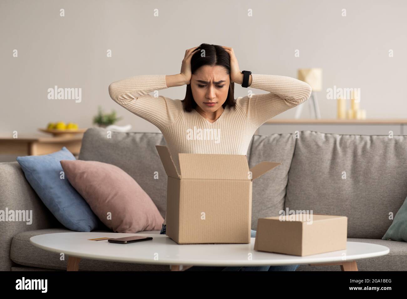 Wrong parcel, sad with bad delivery service Stock Photo - Alamy