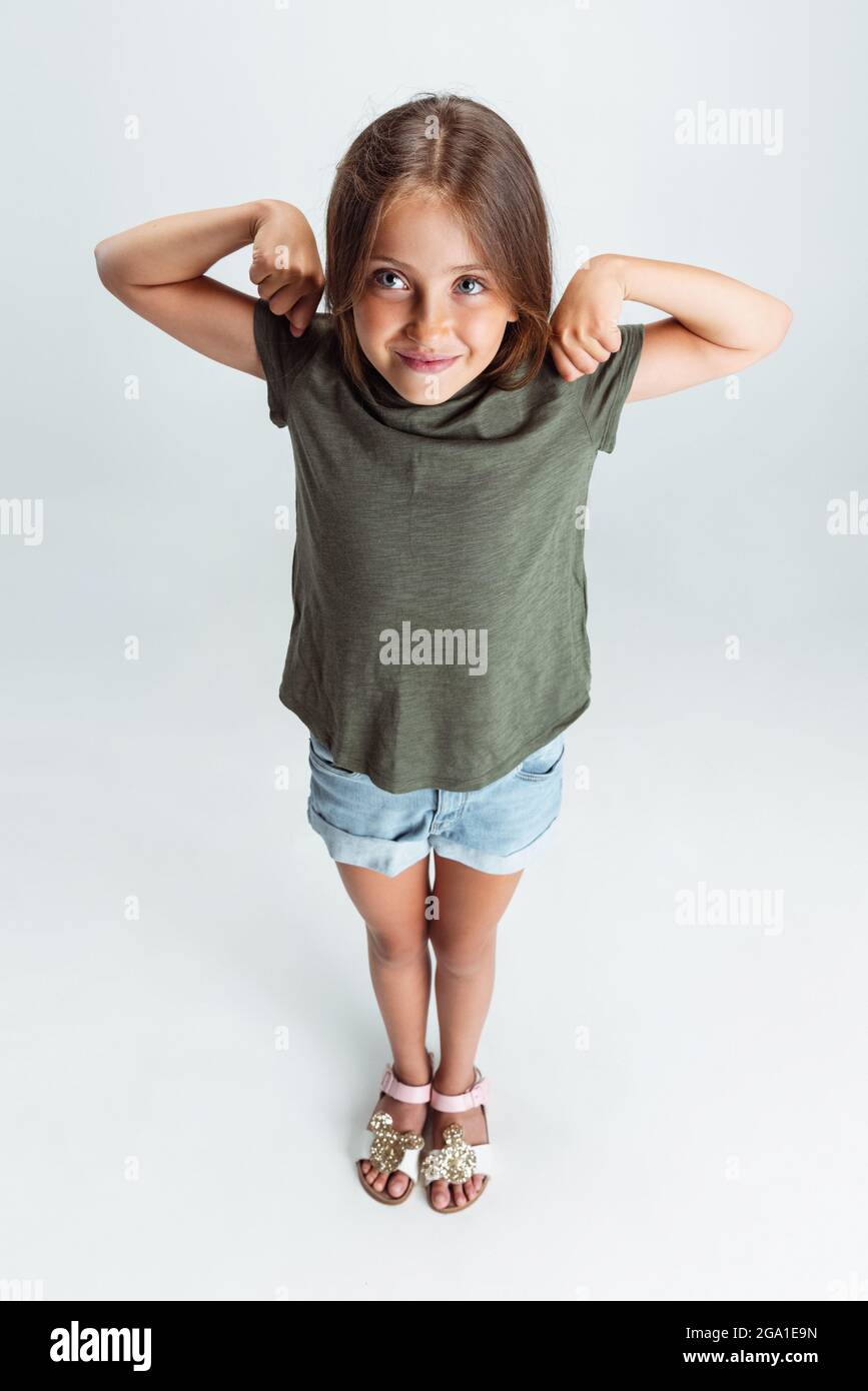 High angle view of beautiful preschool smiling girl isolated on white ...