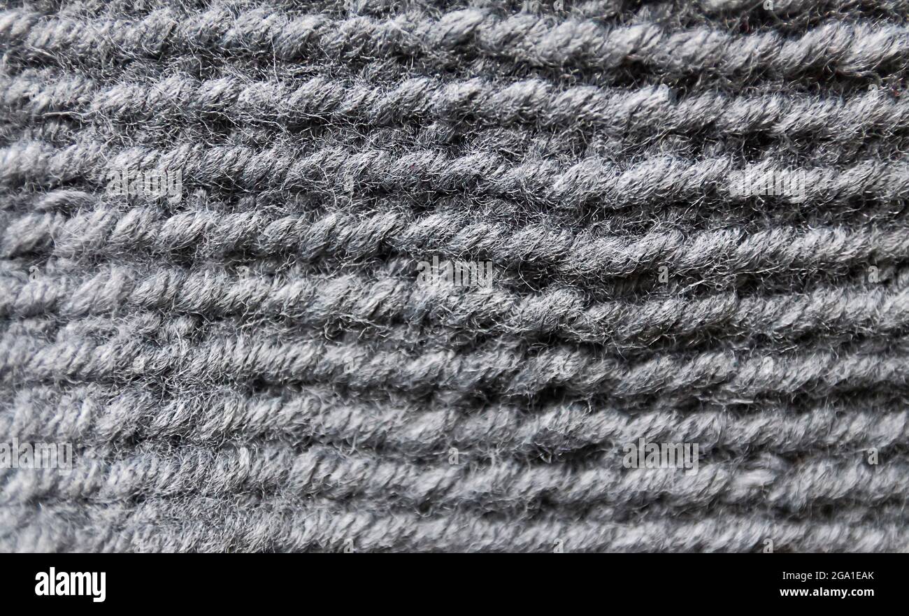 Woolen knitted surface of grey textile close up. Natural textile ...