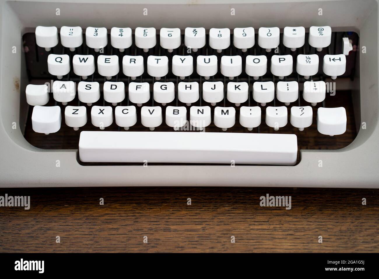 Closeup of a white typing machine keyboard on a wooden table Stock ...