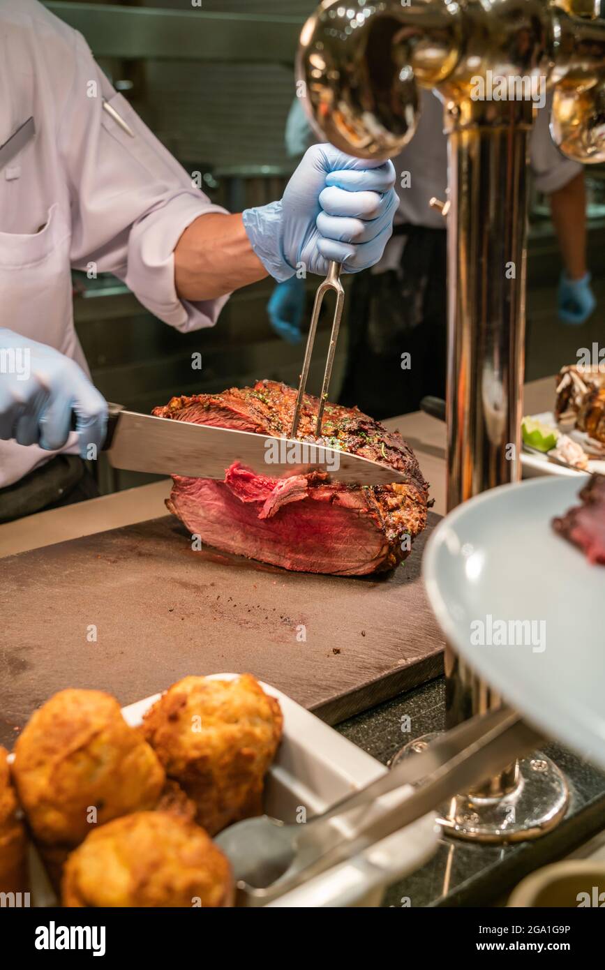 Chef hand cutting BBQ Beef steak with knife and fork Stock Photo - Alamy