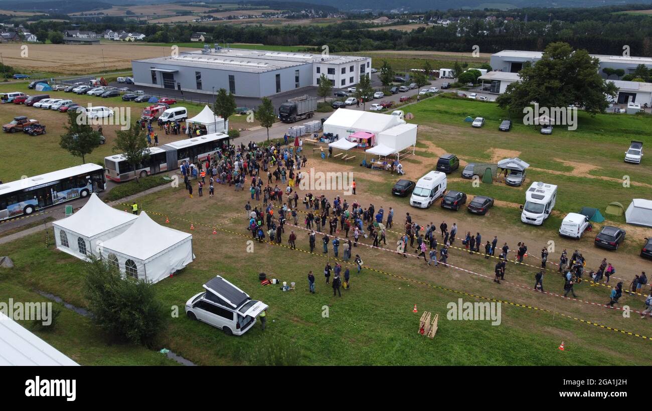 Grafschaft, Germany. 28th July, 2021. Volunteers get off buses at a ...