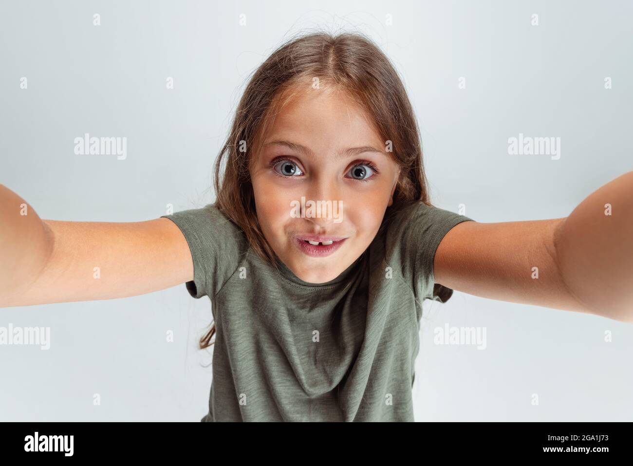 Close-up portrait of beautiful preschool smiling girl looking at camera ...