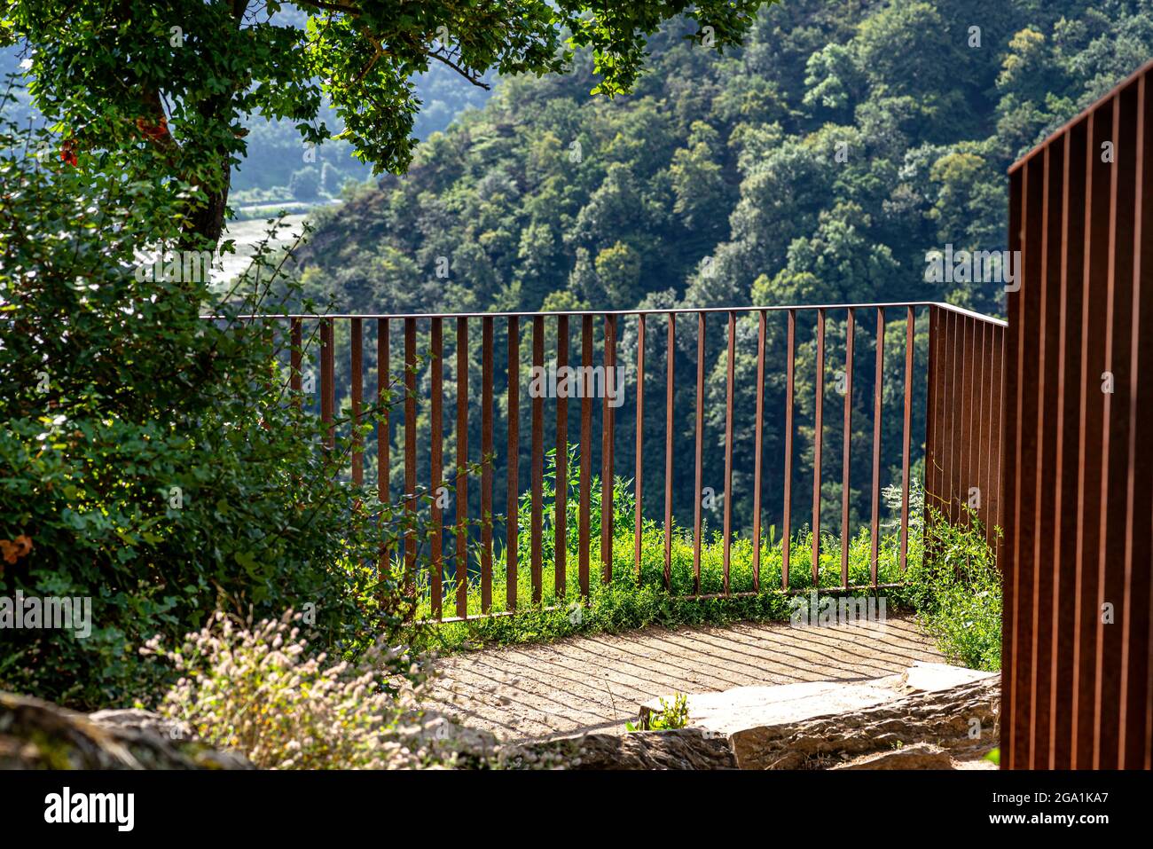 Rusty metal fence at the edge of the river valley, visible trees on the ...