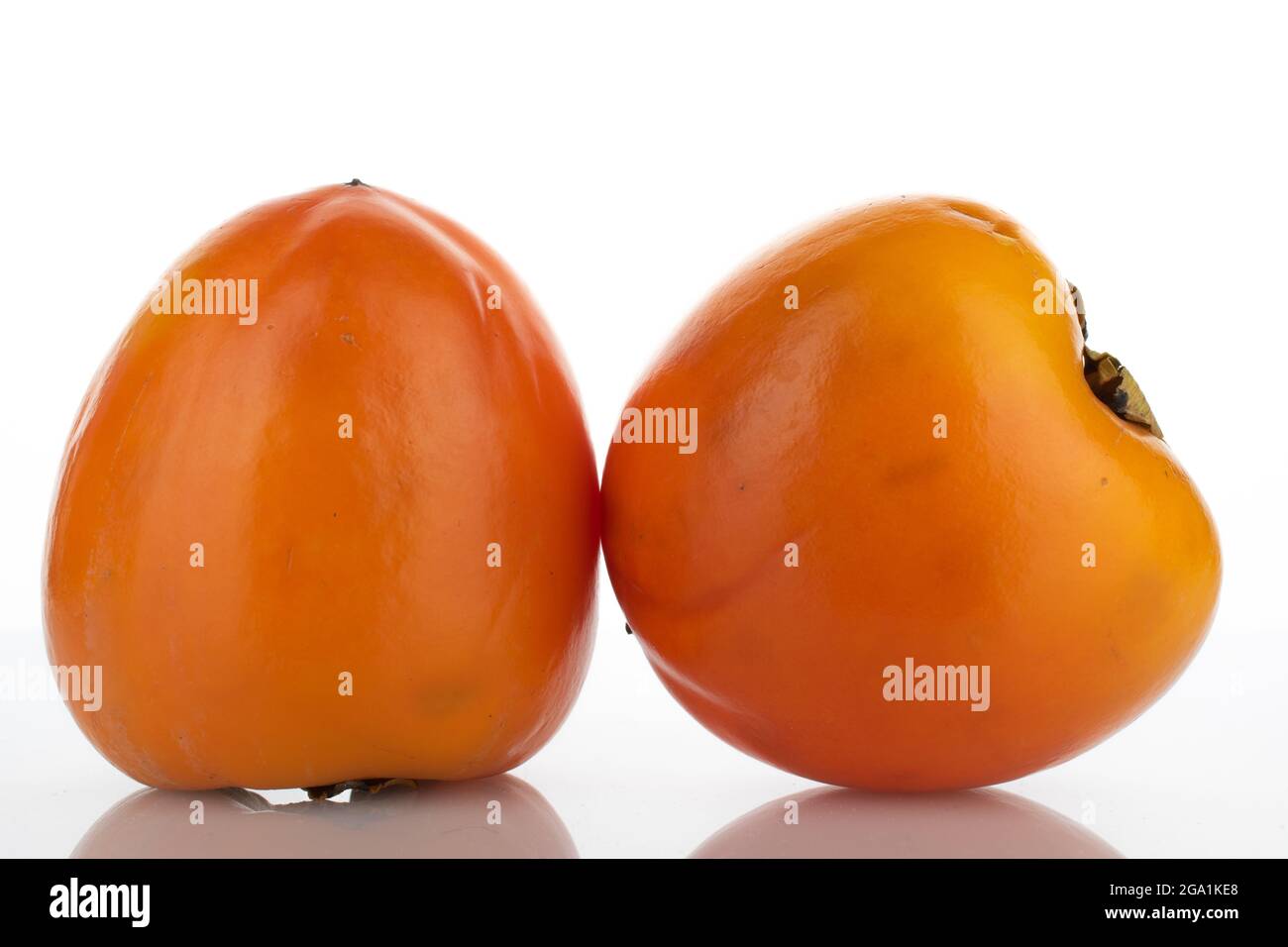 Two ripe organic persimmons, close-up, isolated on white Stock Photo ...