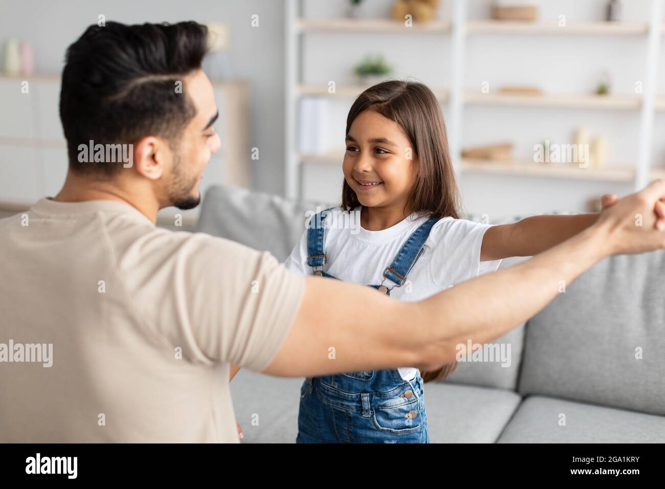 Dad and daughter dancing in living room together Stock Photo - Alamy