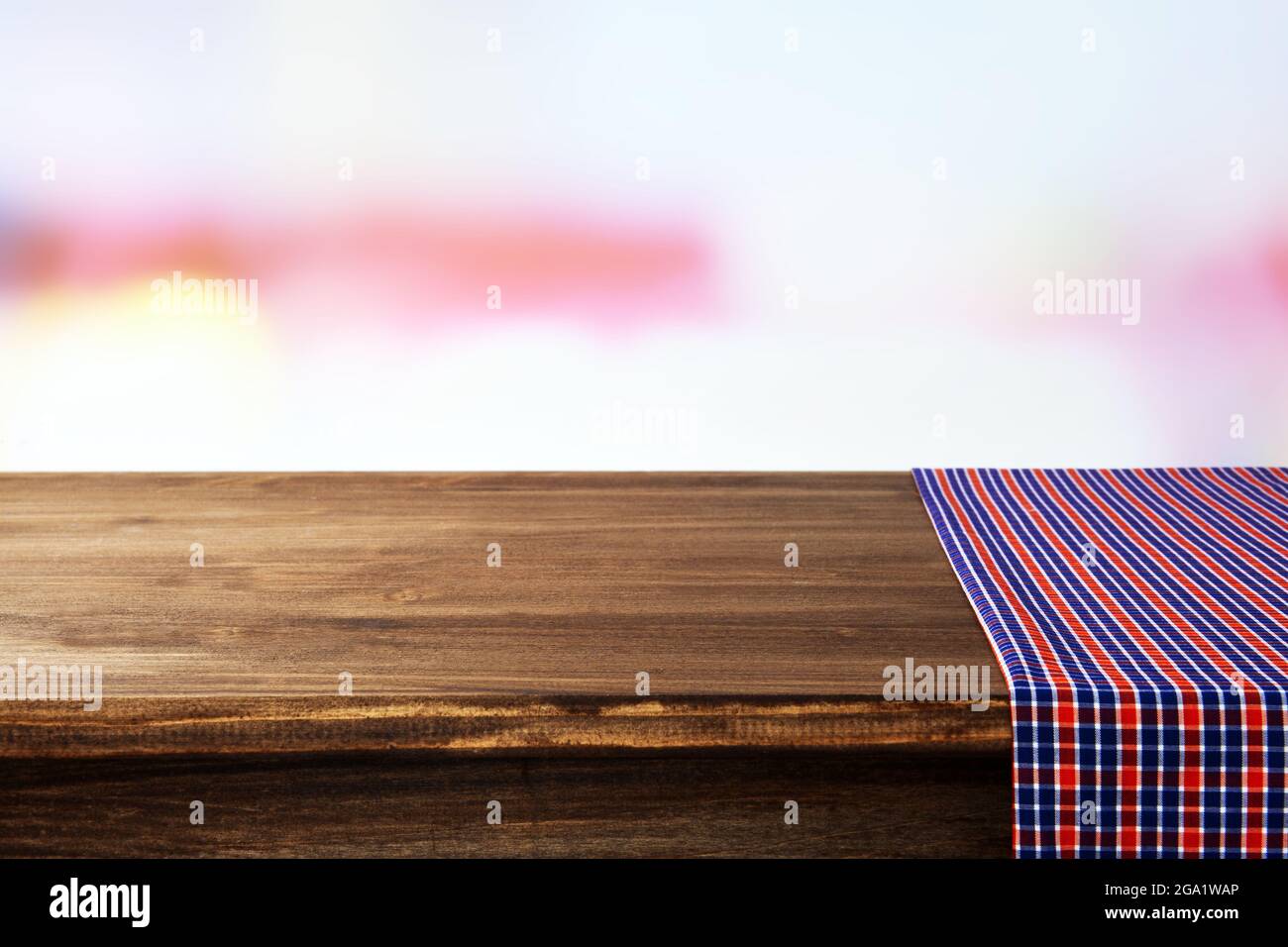 Empty wooden table with napkin and light background Stock Photo - Alamy