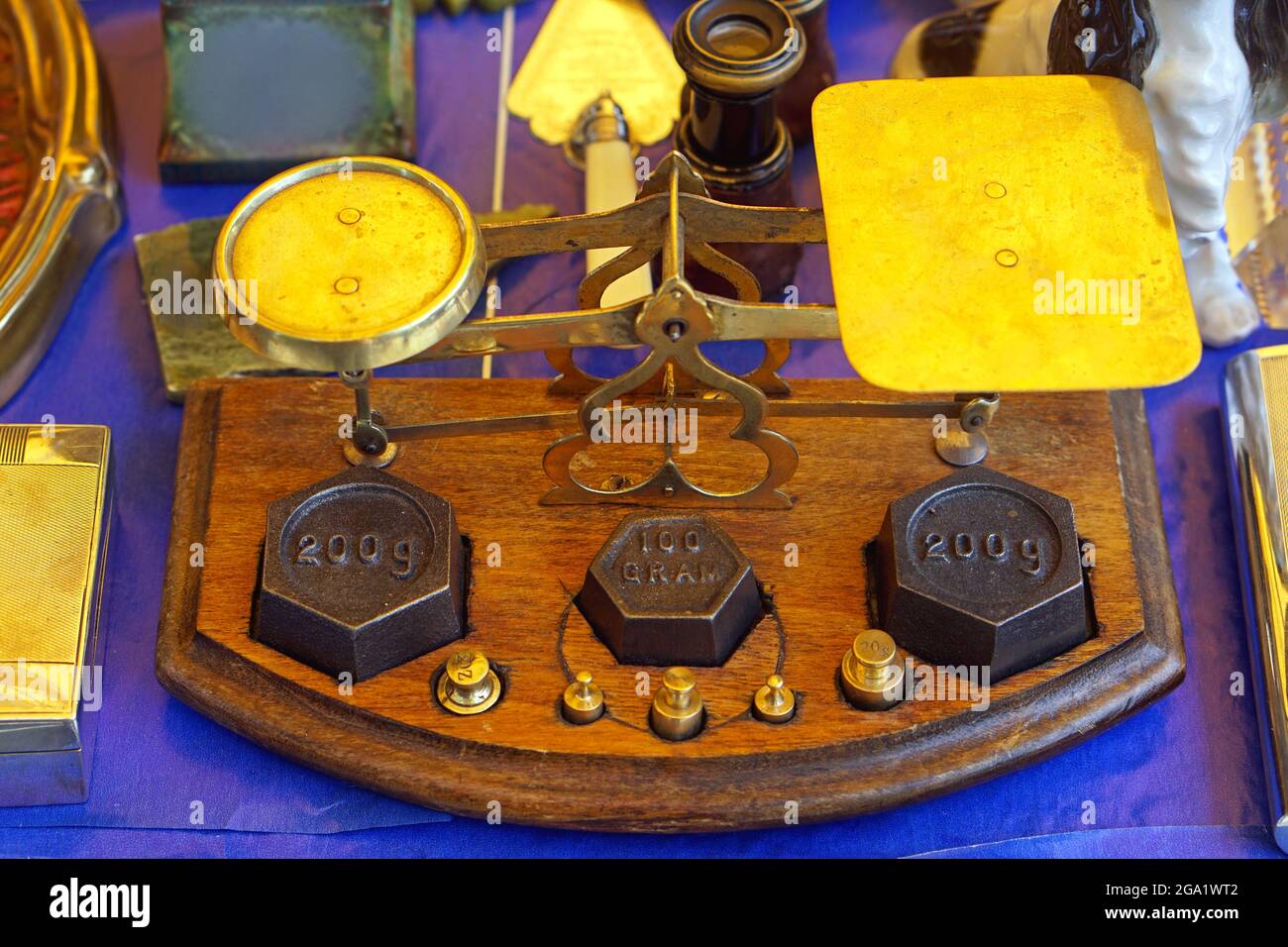 Small golden scale with weights at antique market Stock Photo - Alamy
