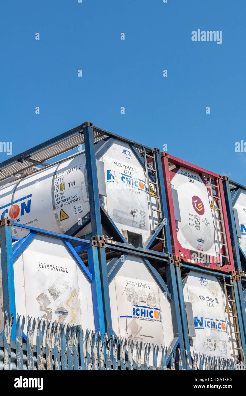 containers and containerised tanks stacked at a delivery depot in ...