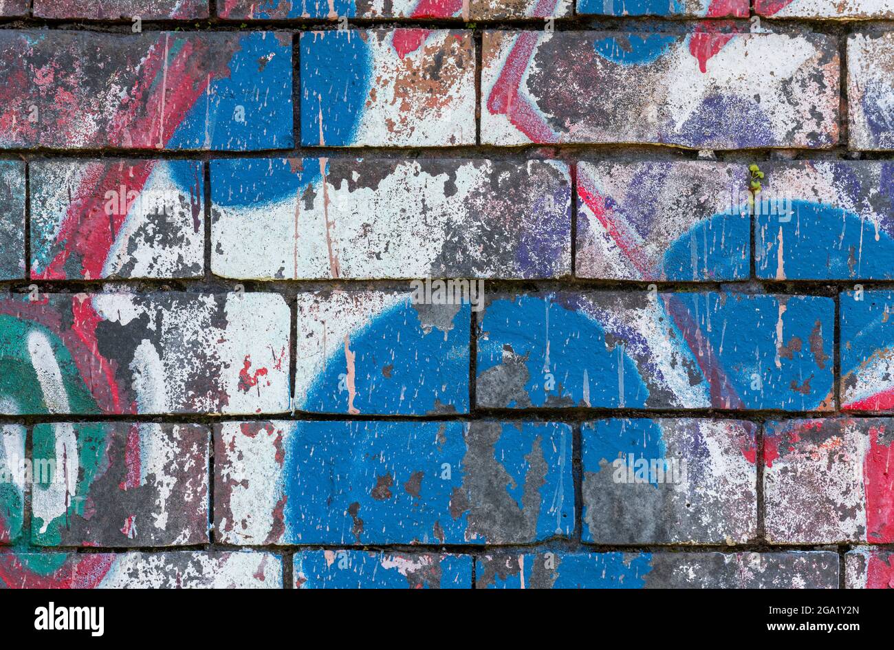 red white and blue patriotic graffiti on a brick wall in an abstract ...