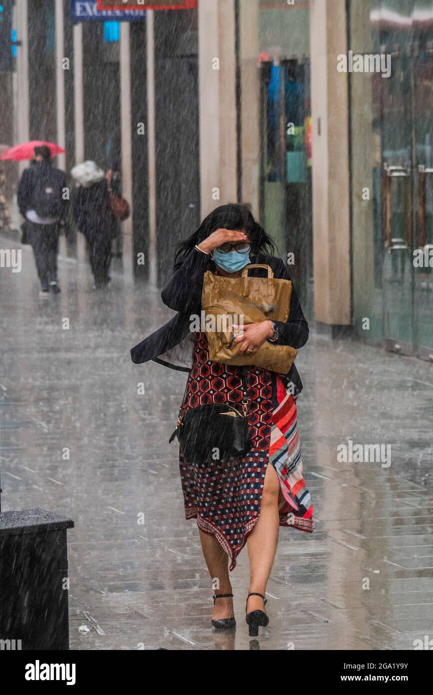 London, UK. 28th July, 2021. Shops are now open but pouring rain in ...