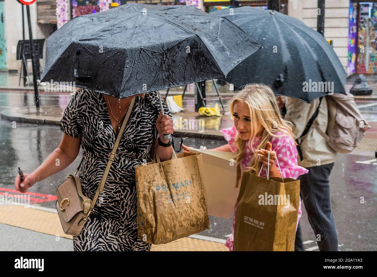 London, UK. 28th July, 2021. Shops are now open but pouring rain in ...