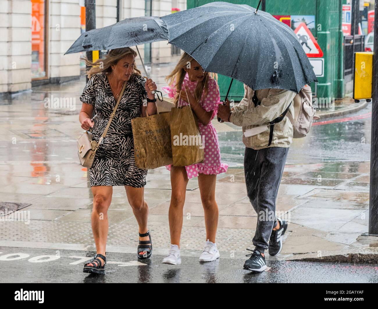 London, UK. 28th July, 2021. Shops are now open but pouring rain in ...