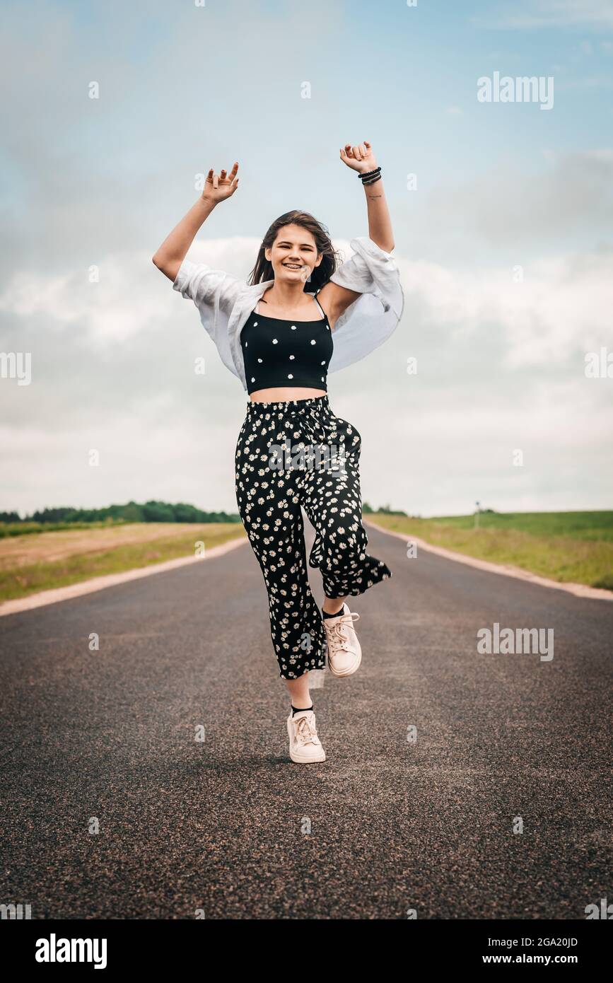 teenager girl dancing on the road. freedom generation z Stock Photo - Alamy
