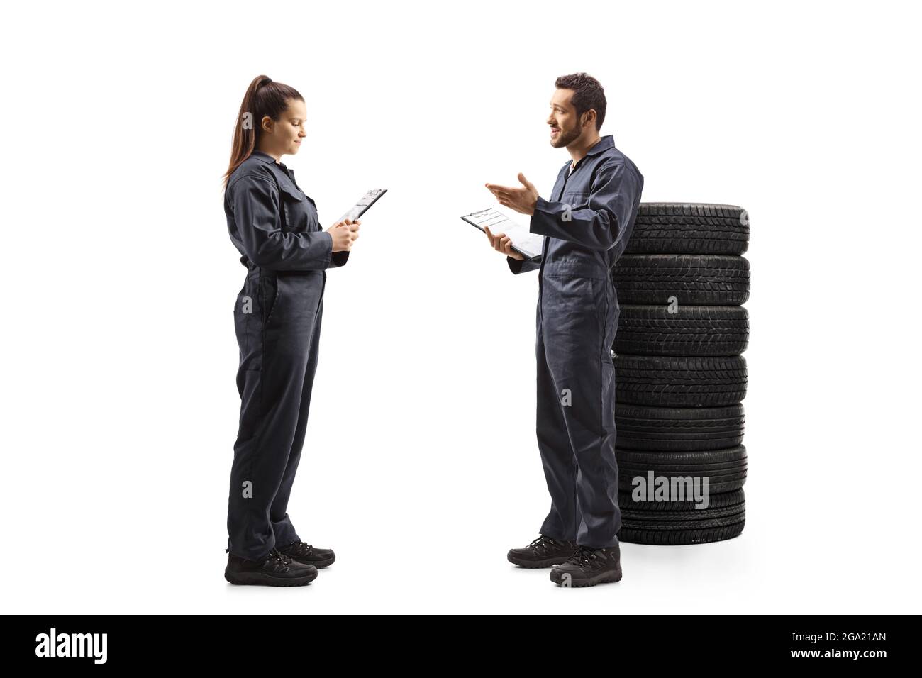 Full length profile shot of a male and female auto mechanic workers ...