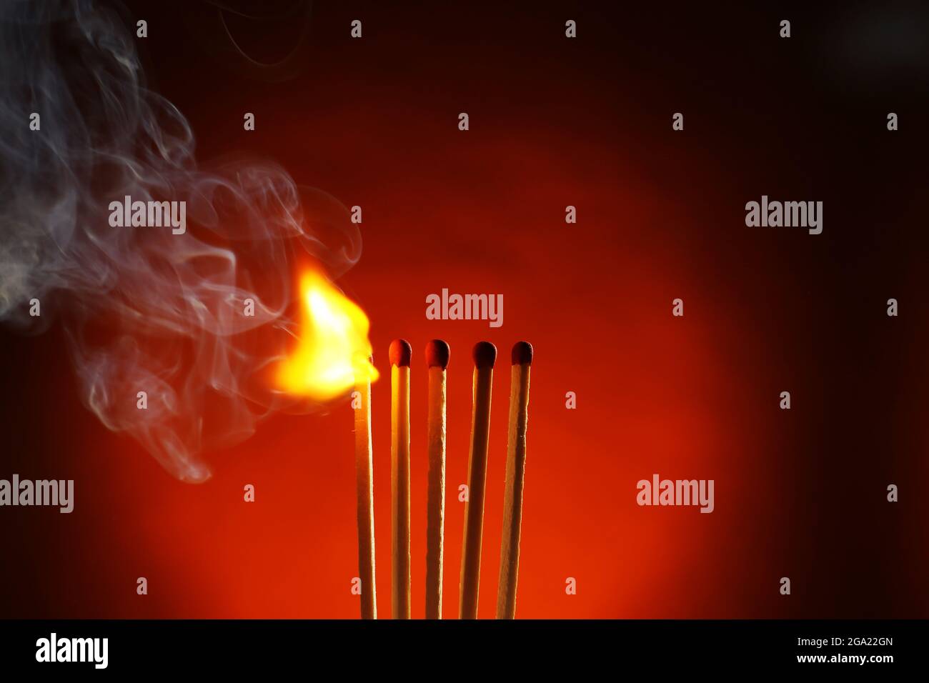 Burning matches with smoke on dark color background Stock Photo - Alamy