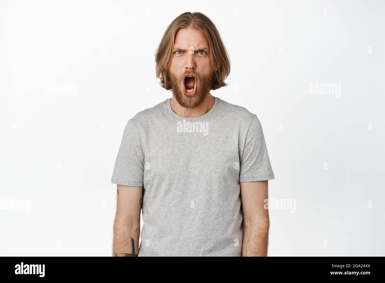 Shocked and frustrated blond bearded man, drop jaw, gasping startled ...