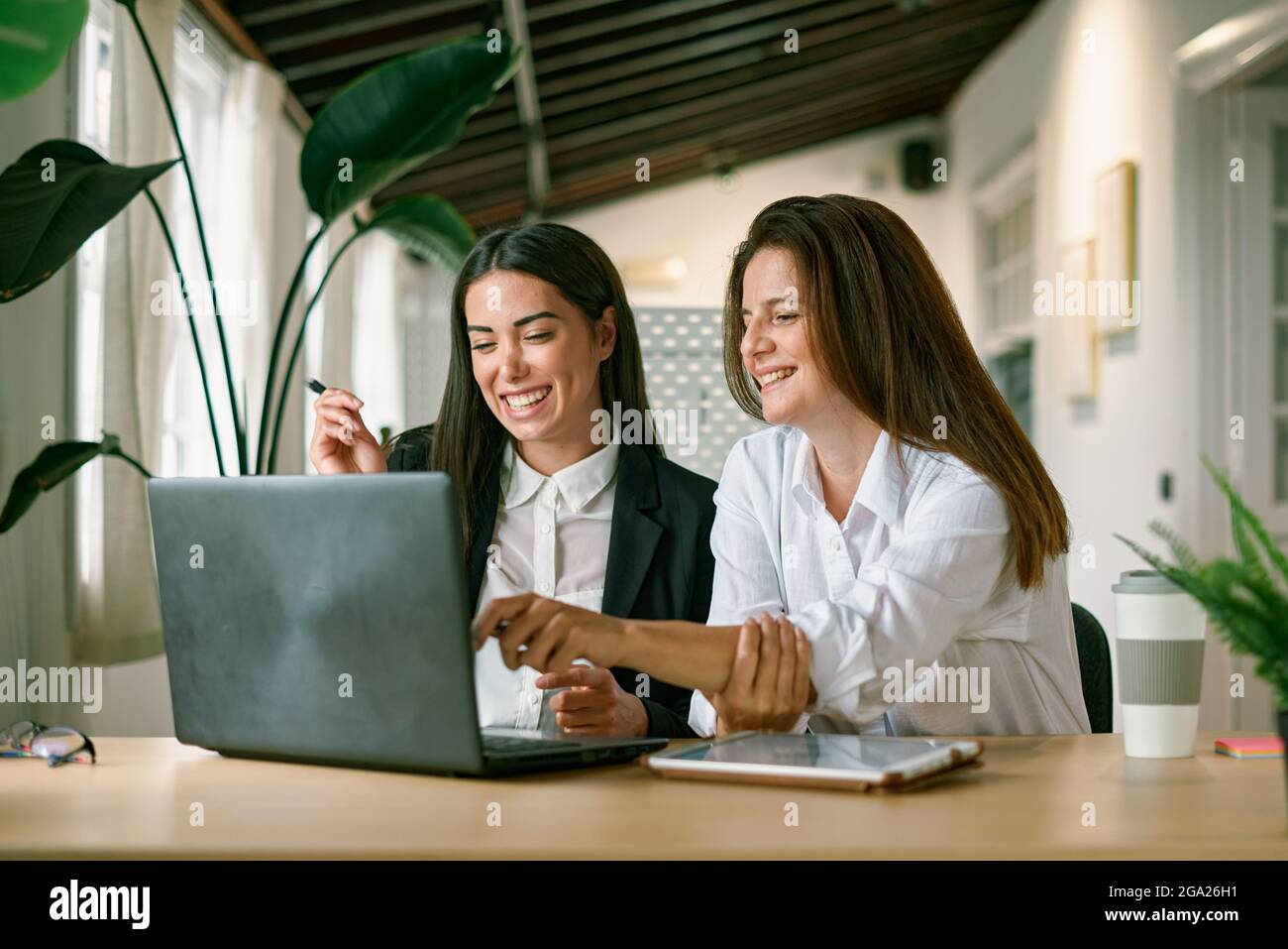Colleagues looking laptop together hi-res stock photography and images ...
