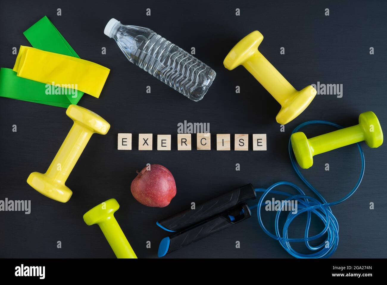 Sports equipment on black background for exercising at home. Word ...