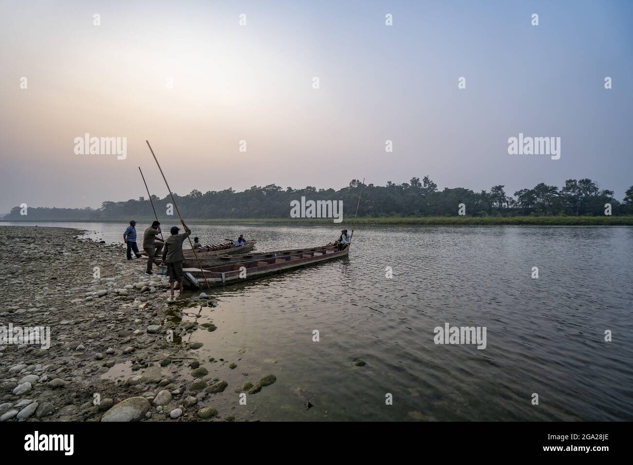 Tourists on canoe safari on the Rapti River in the Chitwan National ...