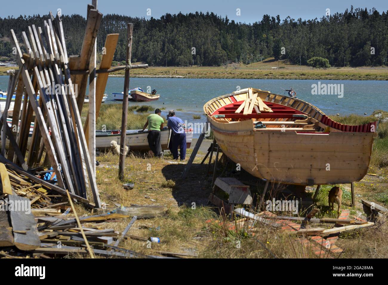 Building a new fishing boat on the riverbank in the rural fishing ...