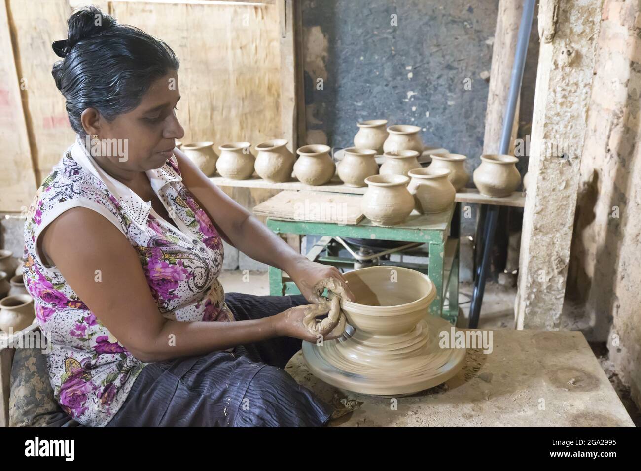 Woman making clay pots in rural village of Sri Lanka; Gampaha District ...