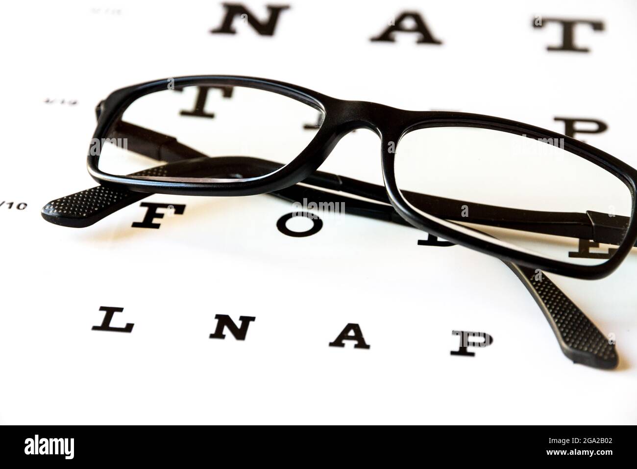 Glasses on eye chart. Optical device background Stock Photo - Alamy