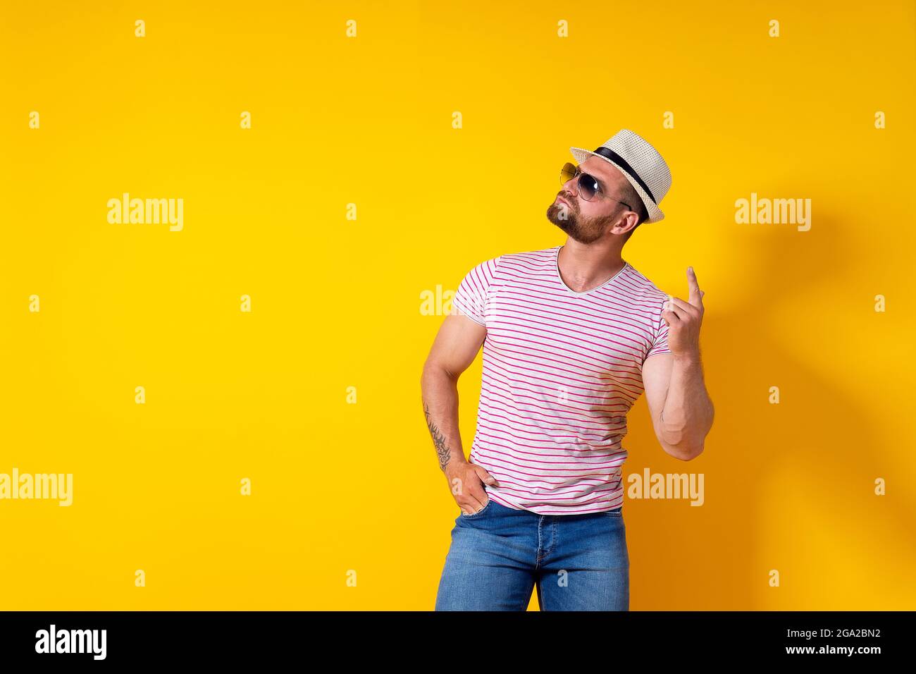 Bearded man in hat and sunglasses pointing finger up Stock Photo - Alamy