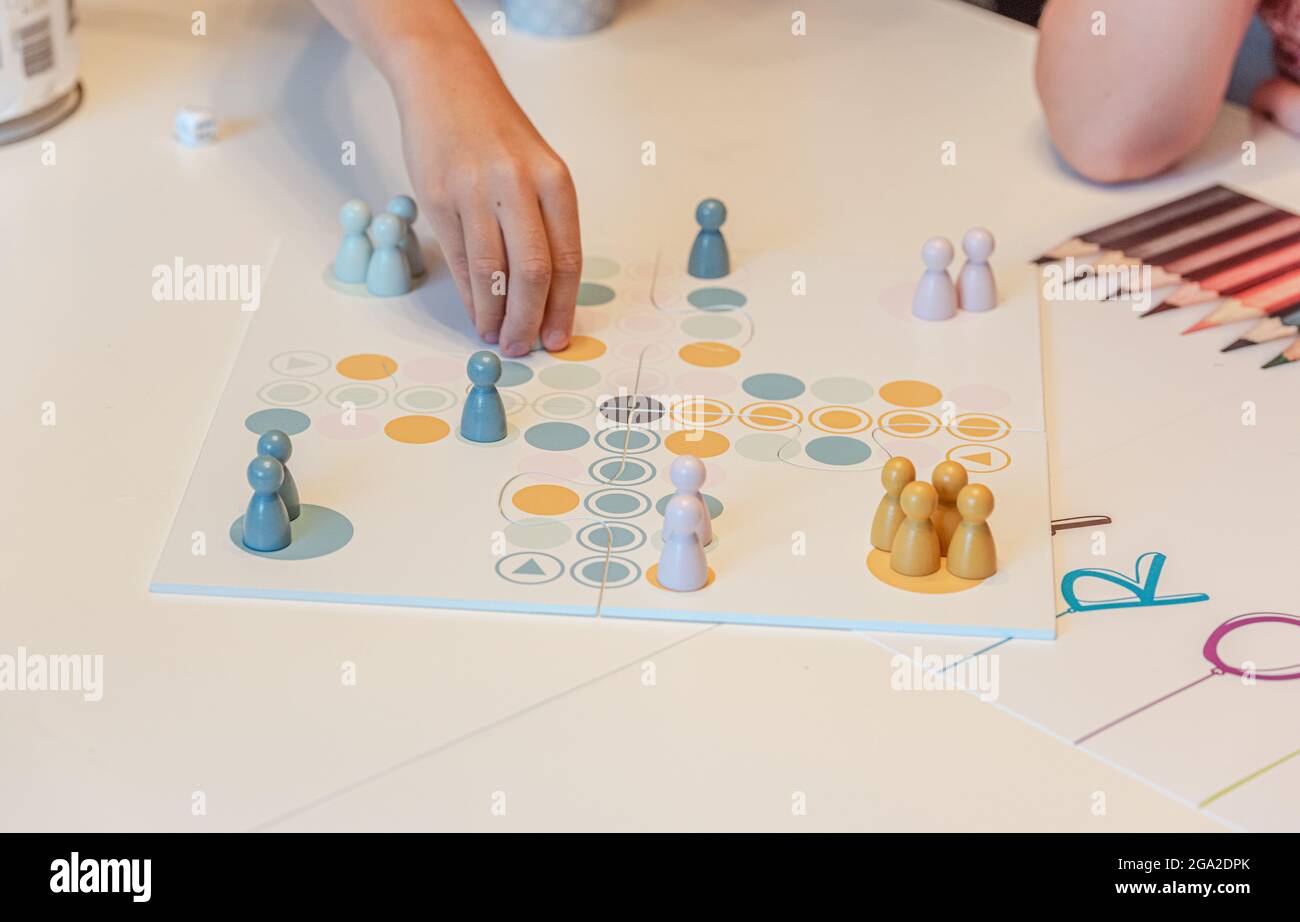 Playing a game of Ludo for four people Stock Photo - Alamy
