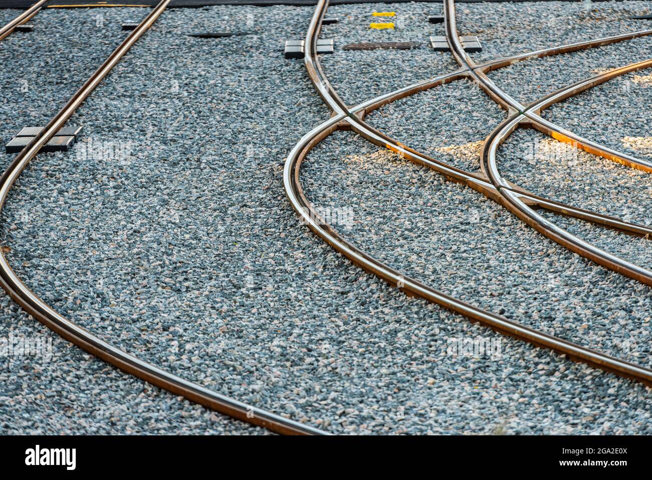 Curved tram rails and a crossing Stock Photo - Alamy